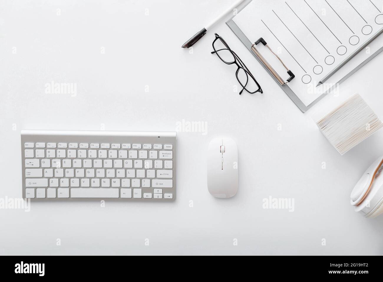Workspace with keyboard mouse glasses papers. Flat lay White desk ...