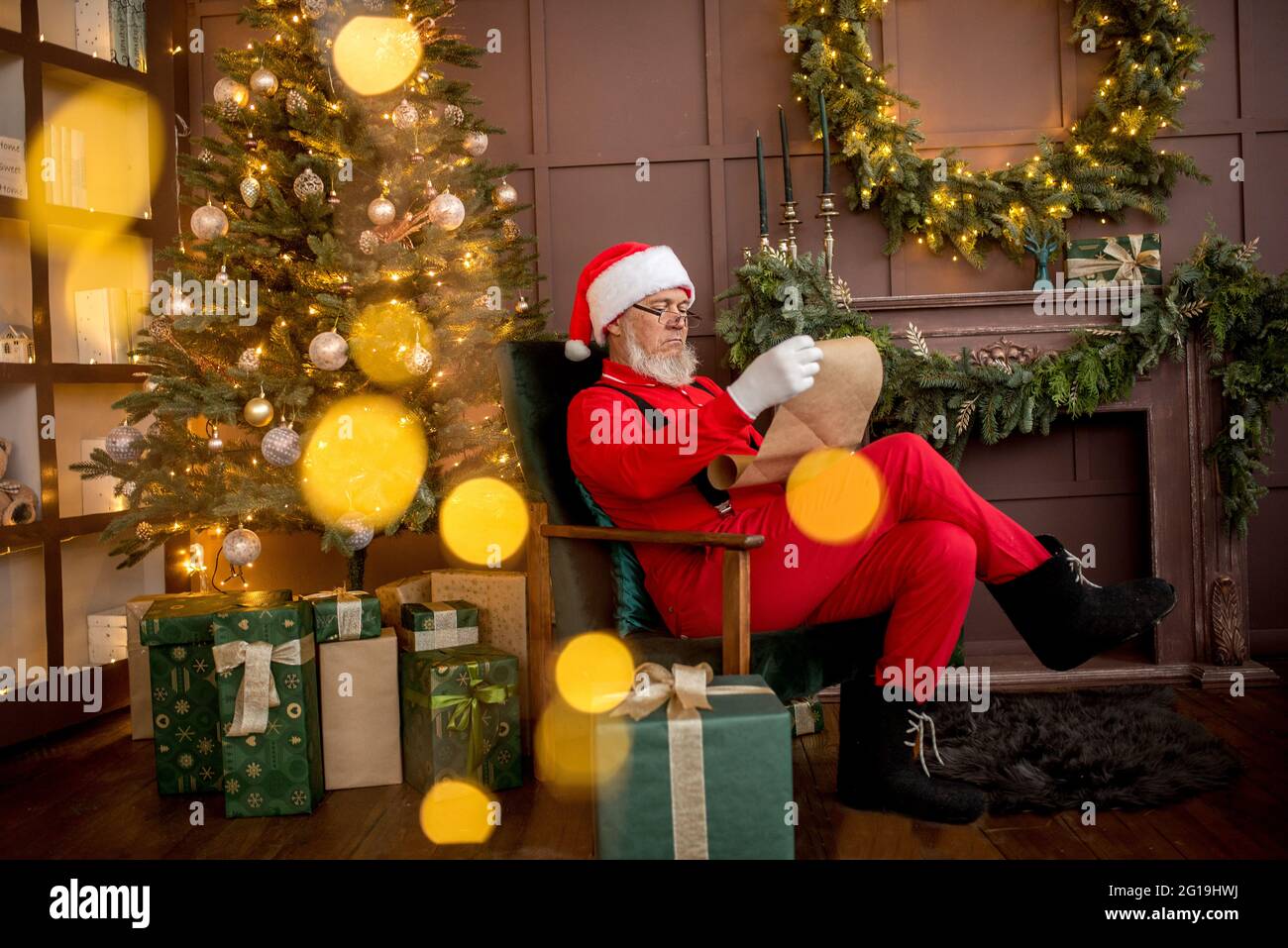 luxury modern Santa at home reads a letter and a children's wish list ...