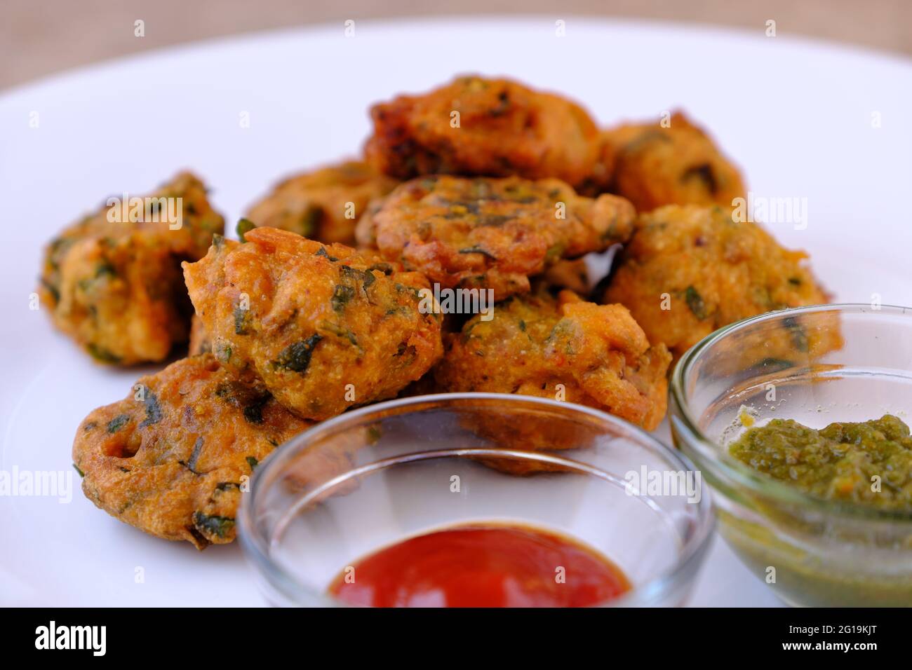 Indian snack pakora with tomato sauce or chutney Stock Photo - Alamy