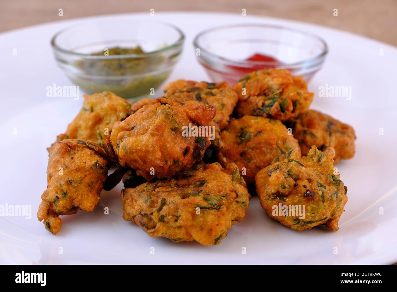 Indian snack pakora with tomato sauce or chutney Stock Photo - Alamy