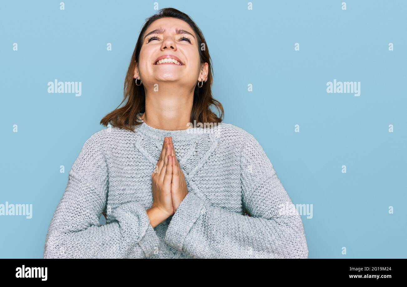 Young caucasian girl wearing casual clothes begging and praying with ...