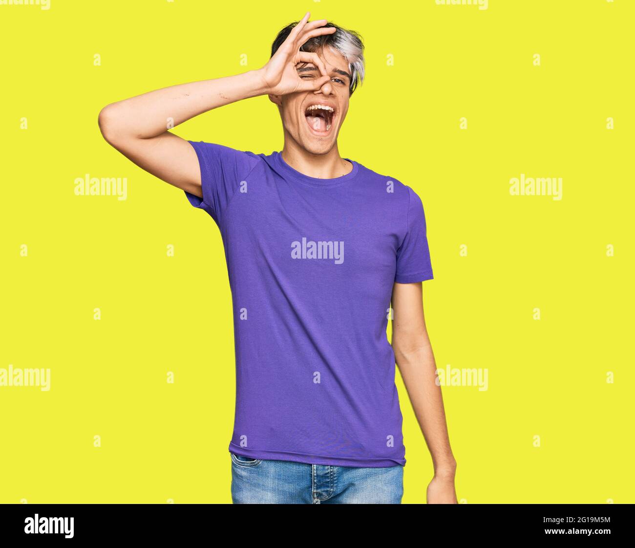 Young hispanic man wearing casual clothes smiling happy doing ok sign ...