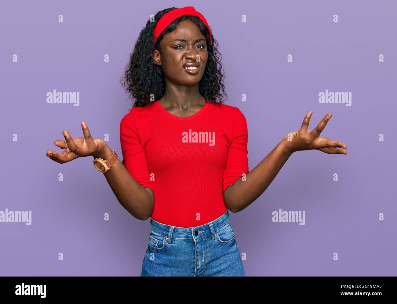 Beautiful african young woman wearing casual clothes clueless and ...