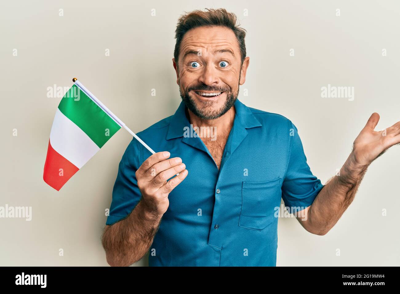 Middle age man holding italy flag celebrating achievement with happy ...