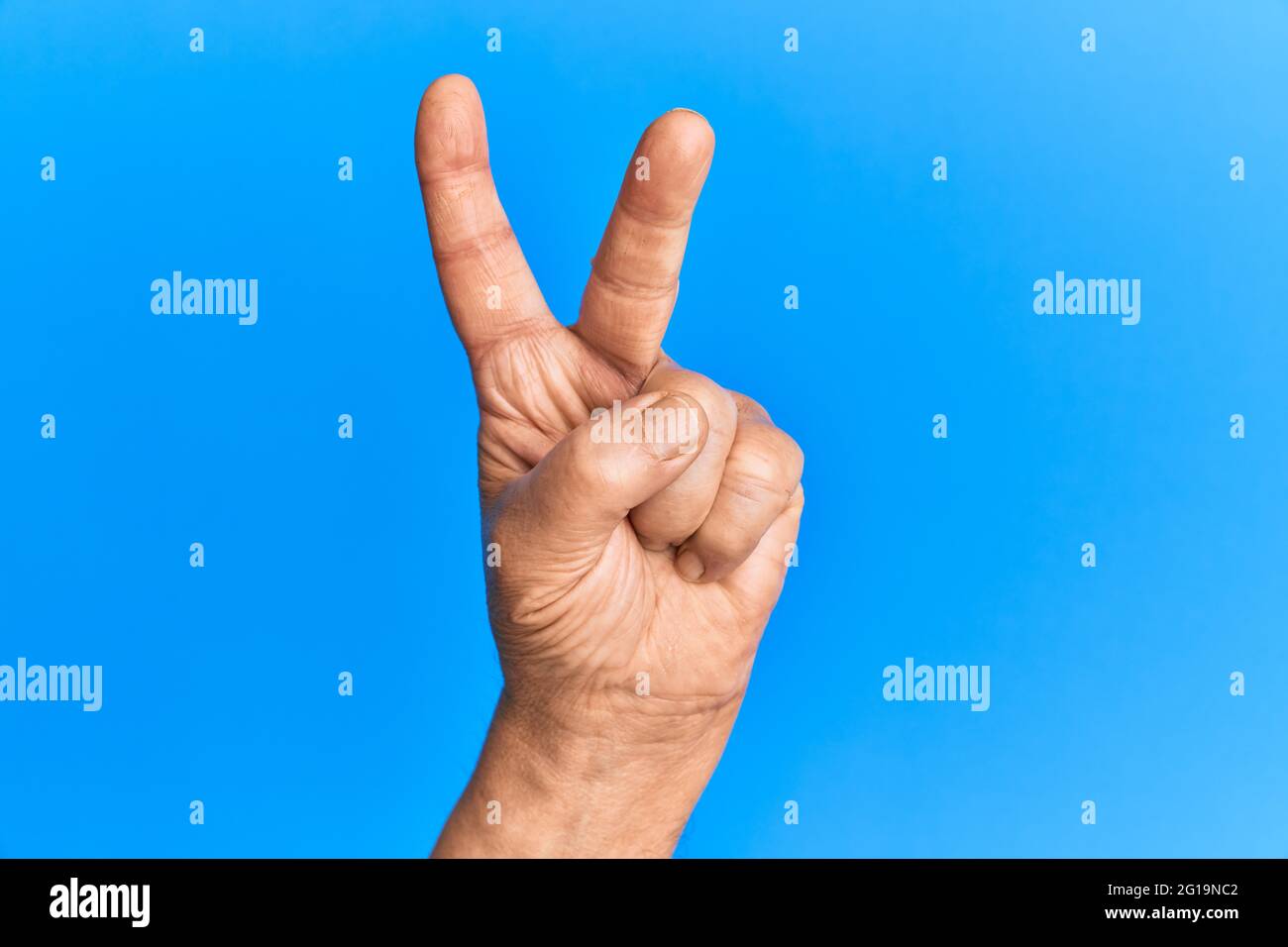 Hand of senior hispanic man over blue isolated background counting ...