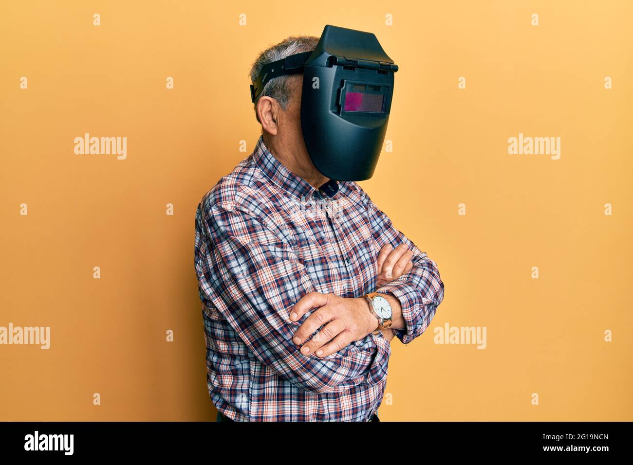 Repair man wearing professional welding mask over head covering face ...
