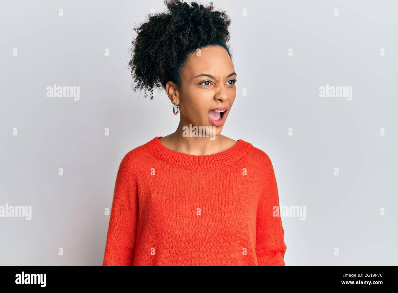 Young african american girl wearing casual clothes angry and mad ...
