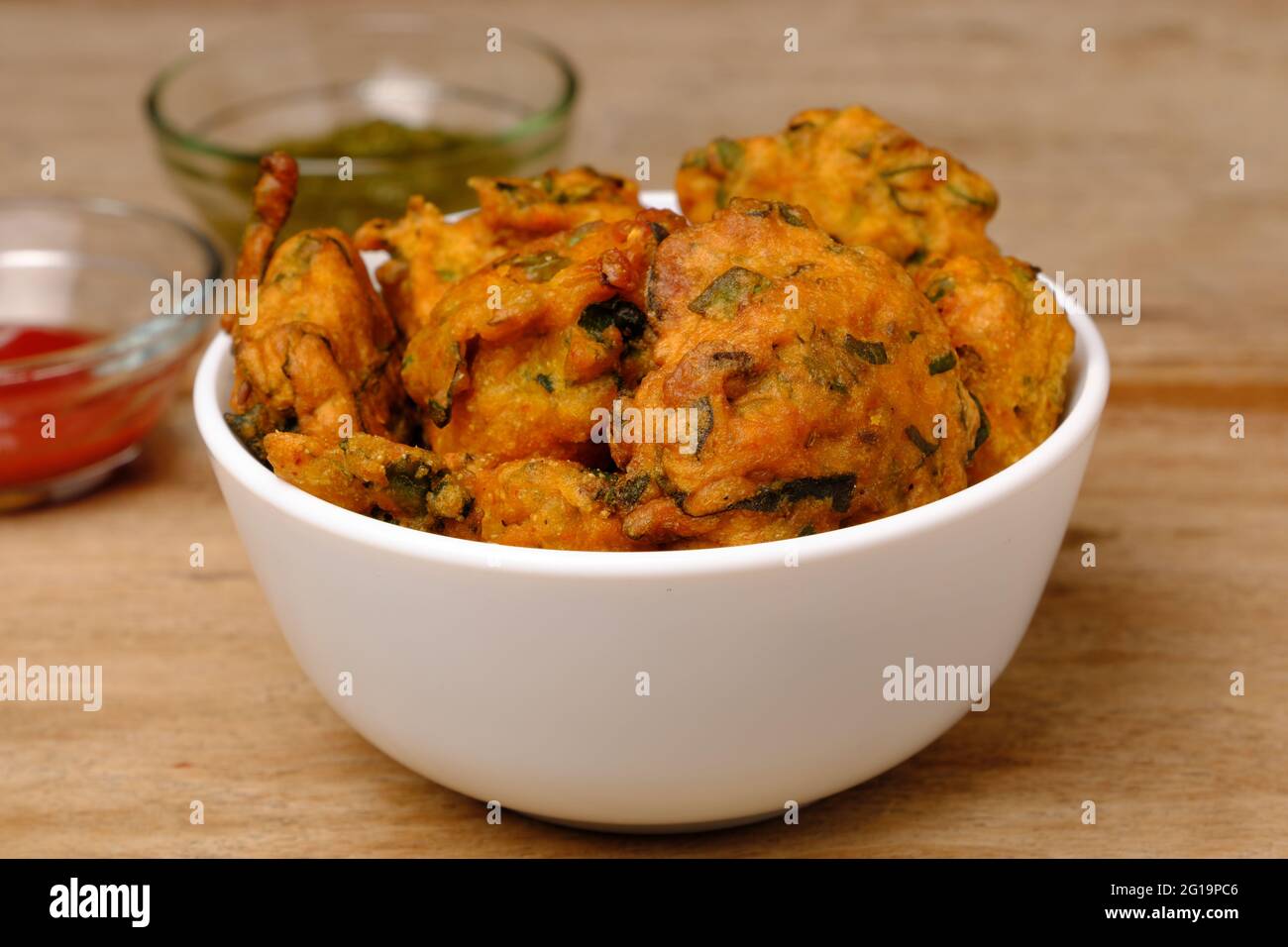 Indian snack pakora with tomato sauce or chutney Stock Photo - Alamy