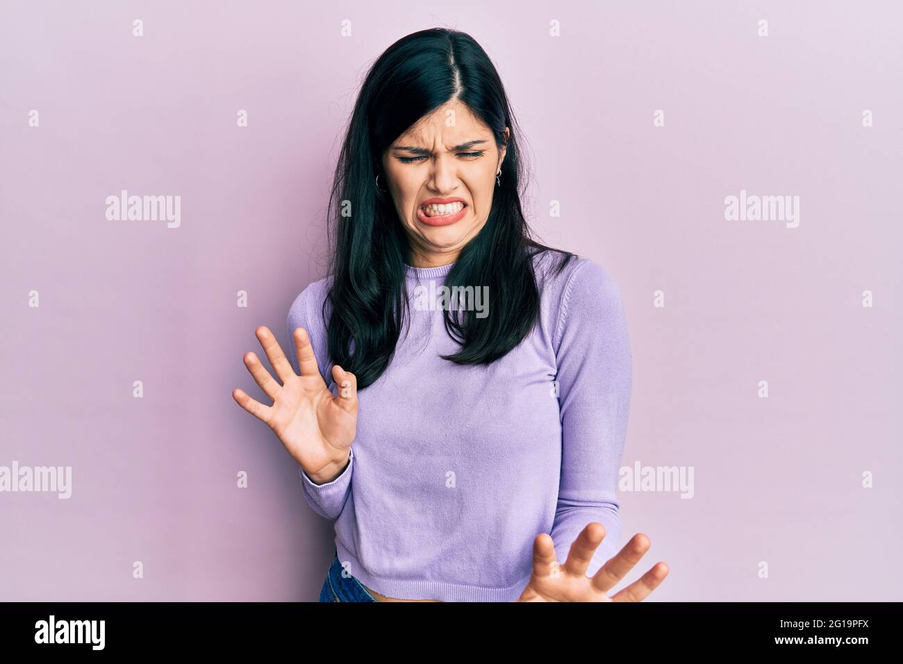 Young hispanic woman wearing casual clothes disgusted expression ...
