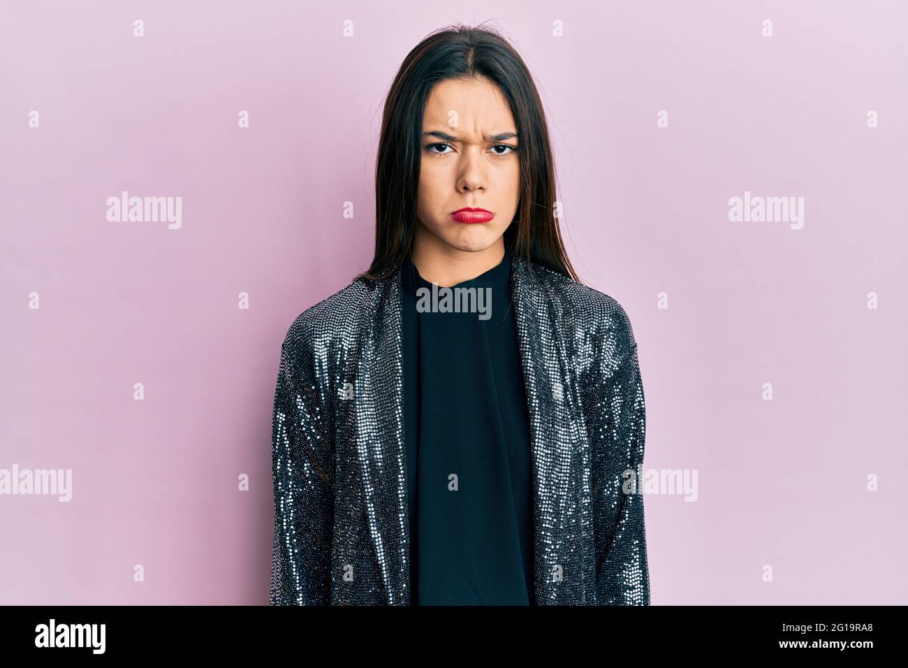 Young hispanic girl wearing party jacket depressed and worry for ...
