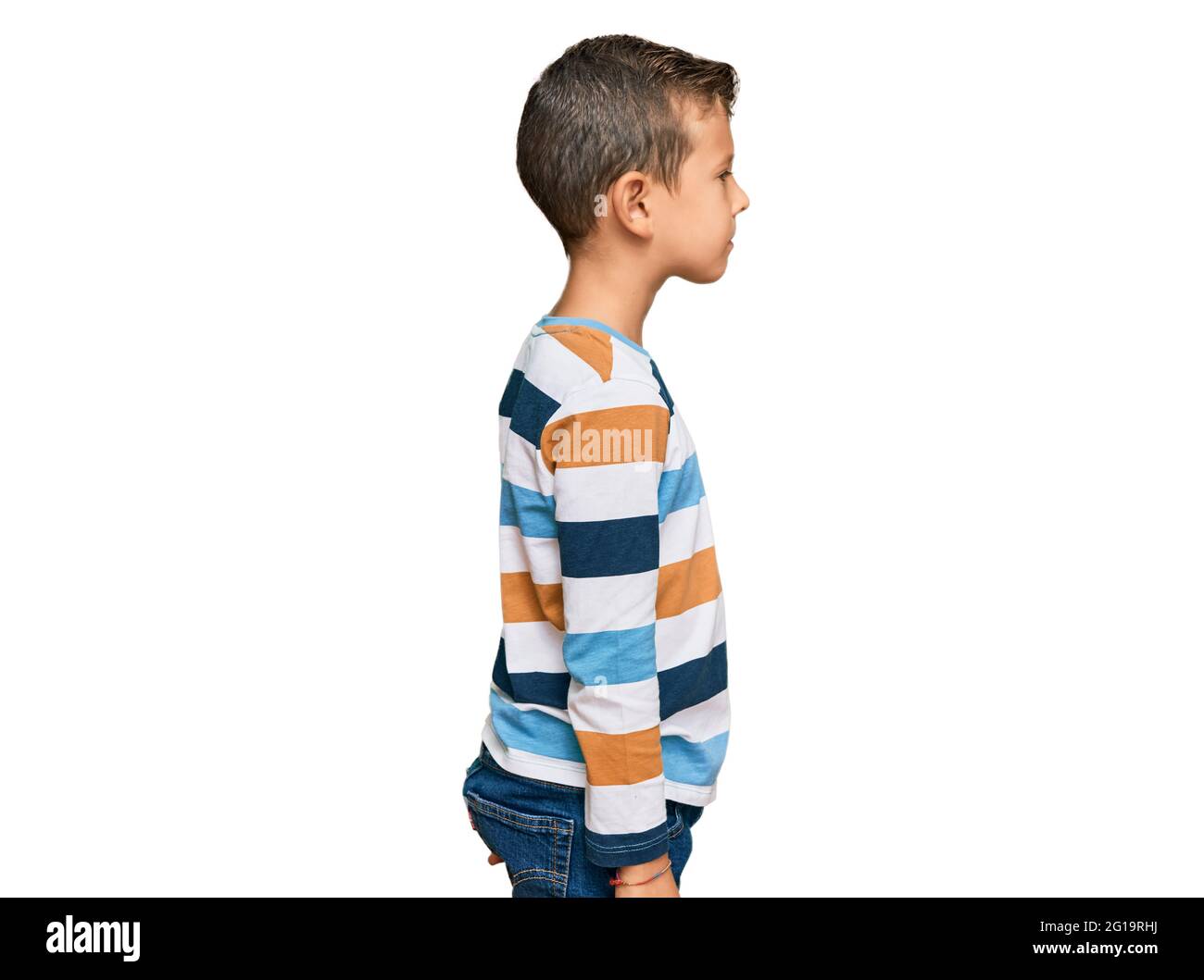 Adorable caucasian kid wearing casual clothes looking to side, relax ...