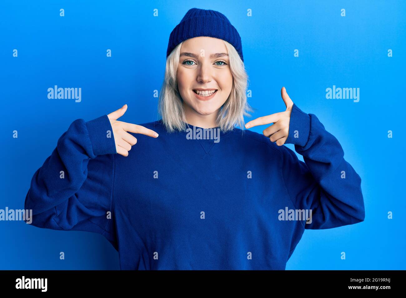 Young blonde girl wearing casual clothes looking confident with smile ...