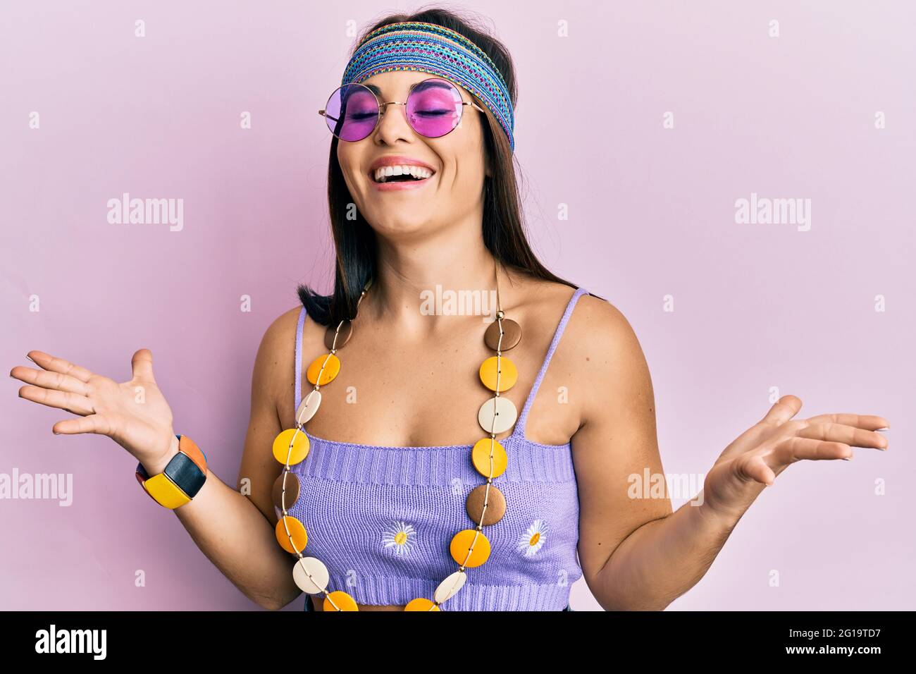 Young brunette woman wearing bohemian and hippie style celebrating mad ...