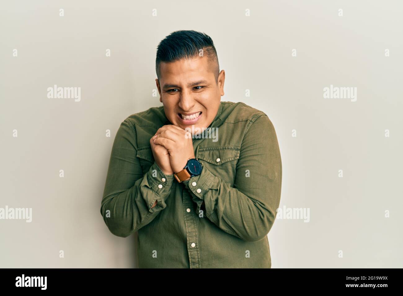 Young latin man wearing casual clothes laughing nervous and excited ...