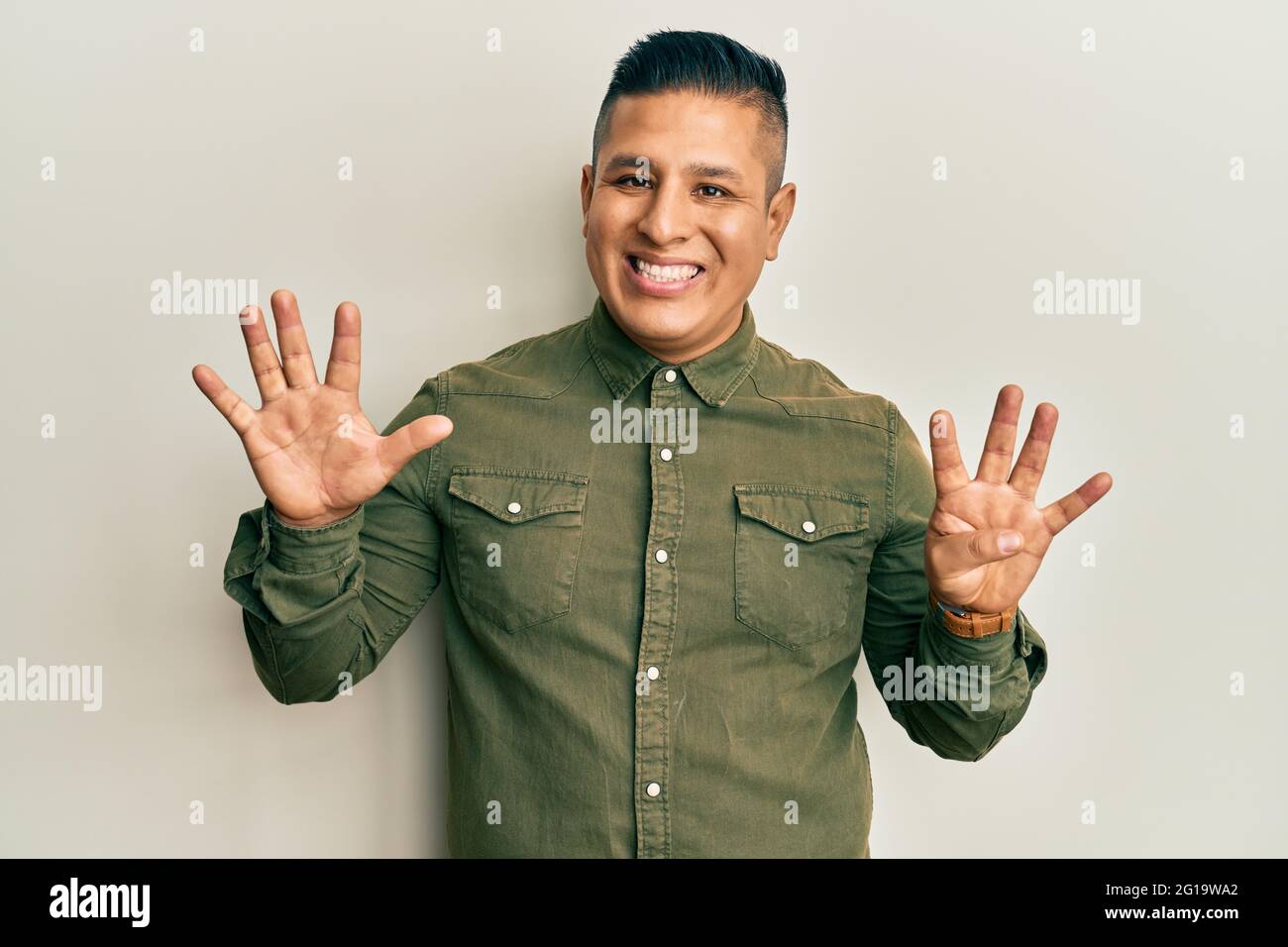 Young latin man wearing casual clothes showing and pointing up with ...