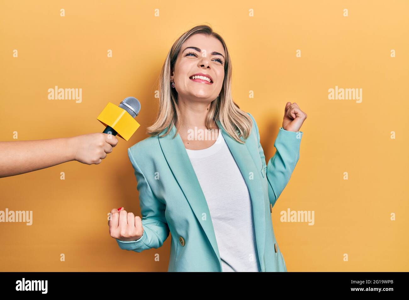 Beautiful caucasian woman being interviewed by reporter holding ...