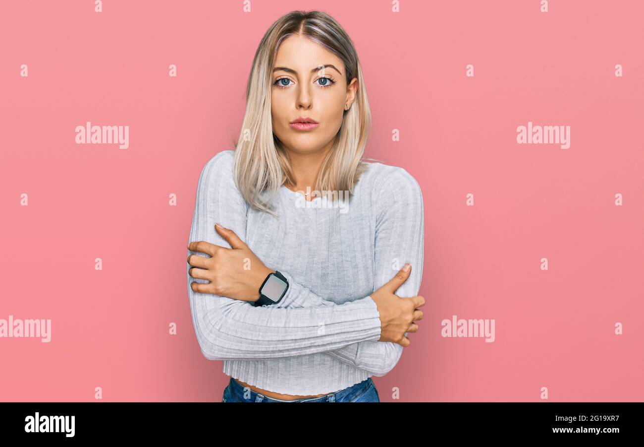 Beautiful blonde woman wearing casual clothes shaking and freezing for ...