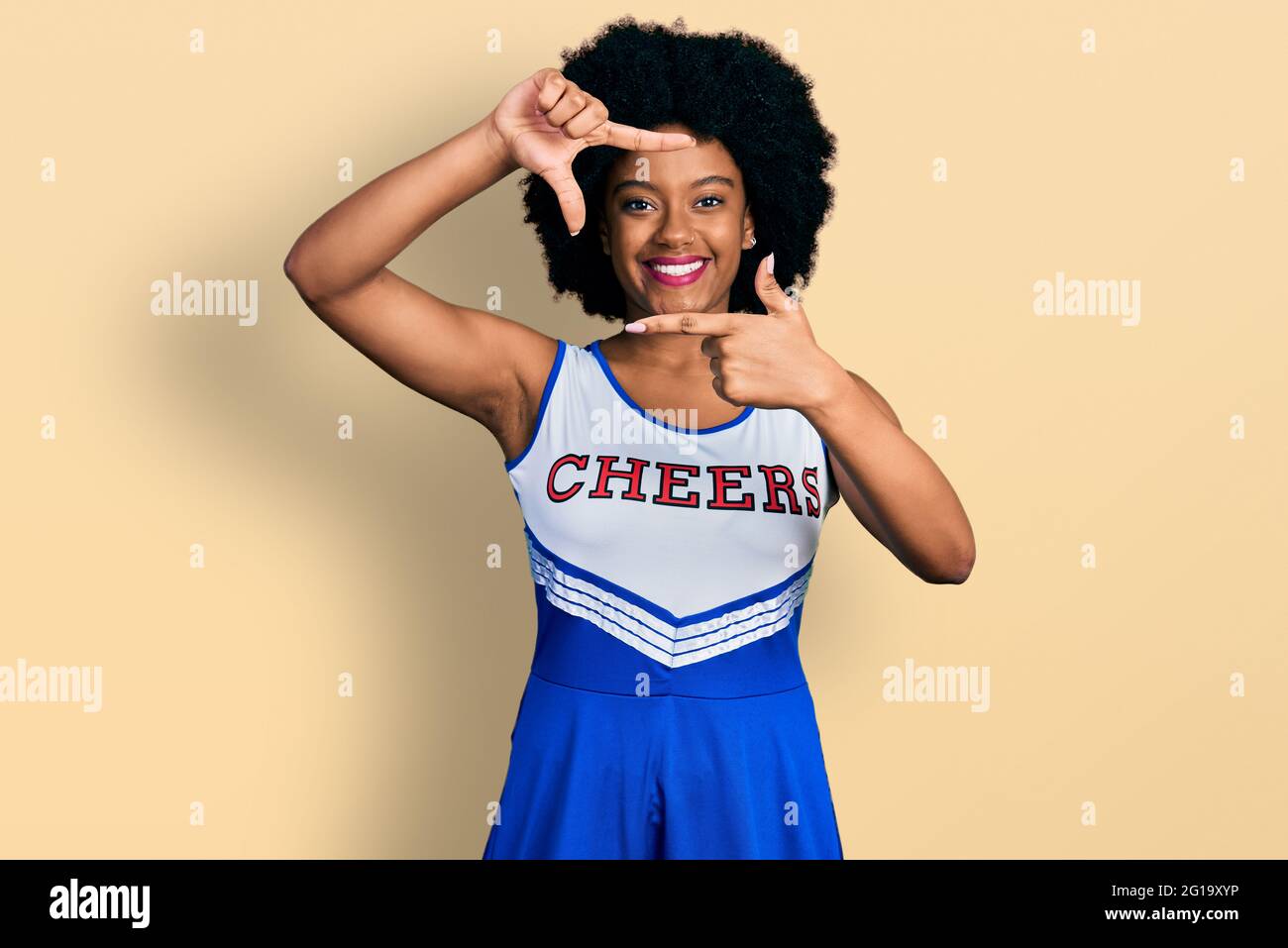 Young african american woman wearing cheerleader uniform smiling making ...