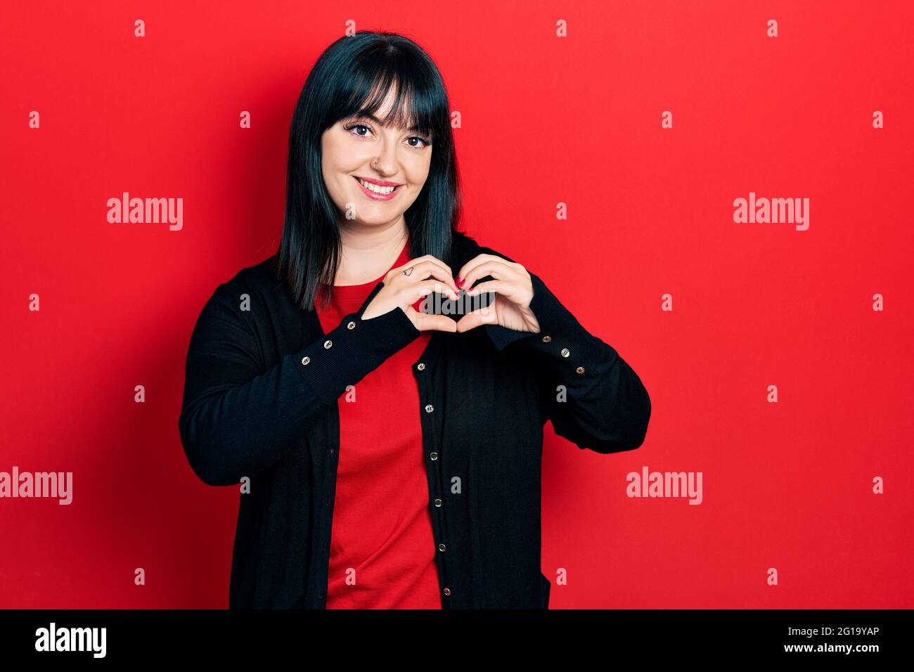 Young hispanic woman wearing casual clothes smiling in love showing ...