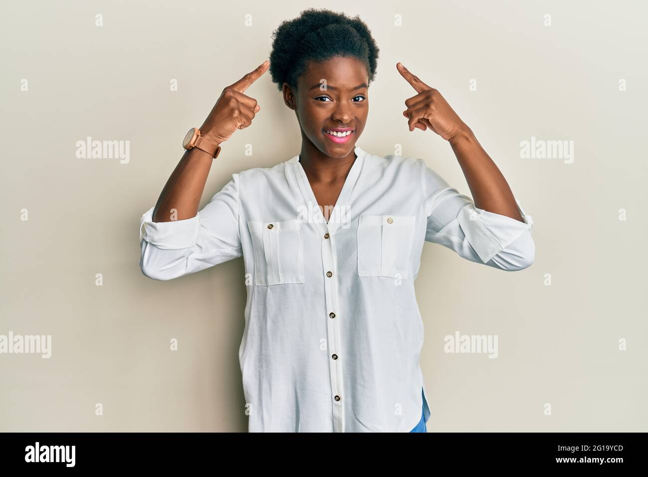 Young african american girl wearing casual clothes smiling pointing to ...