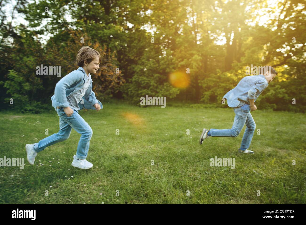 Two boys running in forest hi-res stock photography and images - Alamy