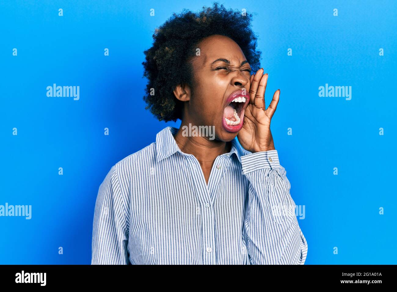 Young african american woman wearing casual clothes shouting and ...