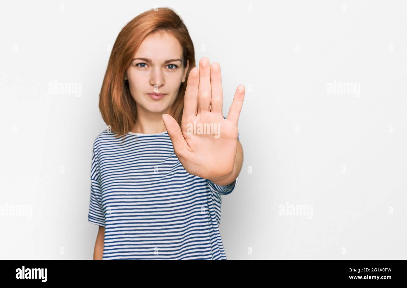 Young caucasian woman wearing casual clothes doing stop sing with palm ...