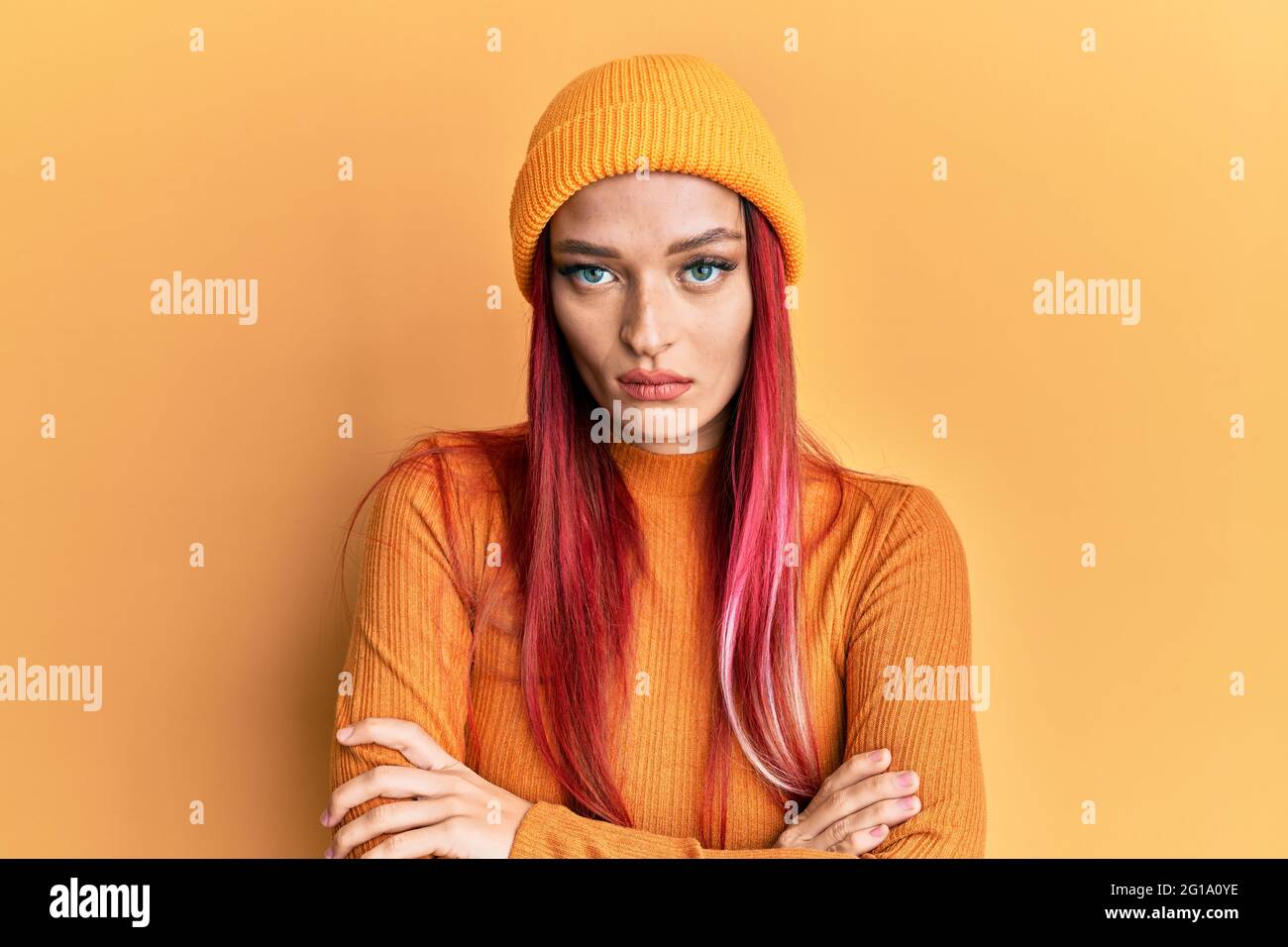 Young caucasian woman wearing wool cap skeptic and nervous ...