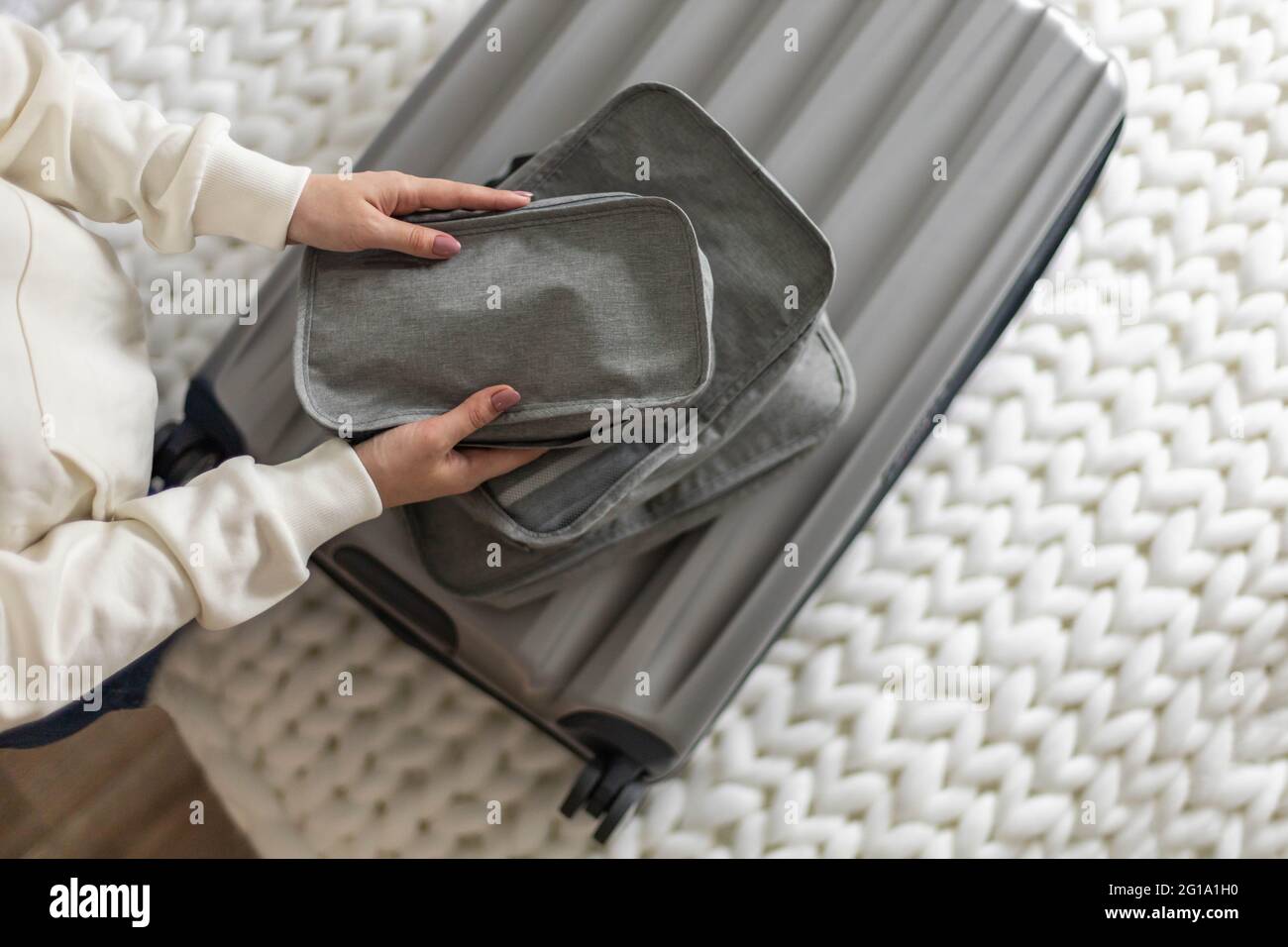 female packing things in briefcase use konmari method getting ready to ...