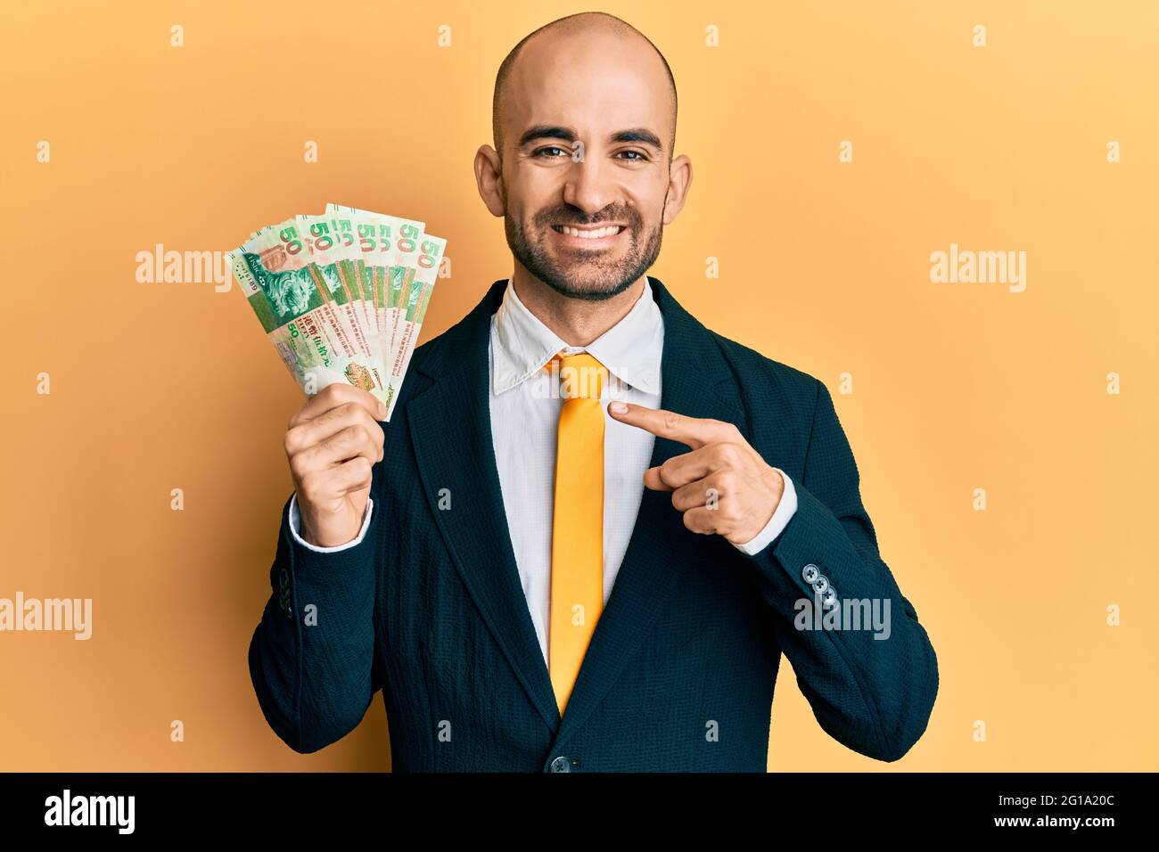 Young hispanic business man holding hong kong dollars banknotes smiling ...