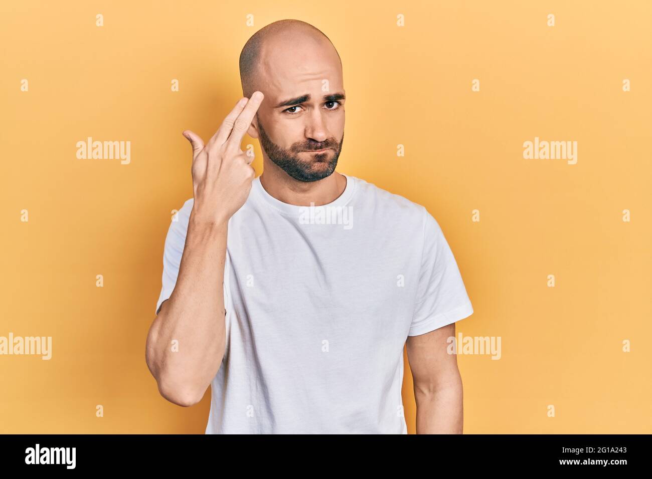 Young bald man wearing casual white t shirt shooting and killing ...