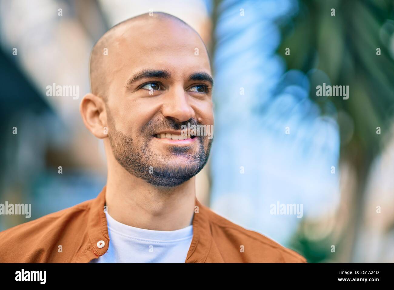 Young hispanic bald man smiling happy standing at the city Stock Photo ...