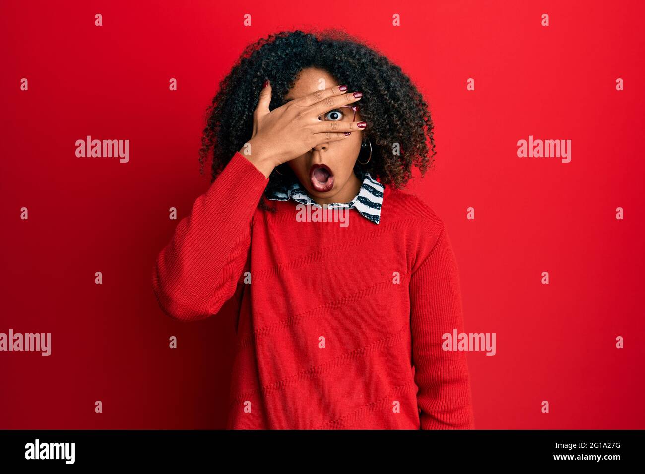 Beautiful african american woman with afro hair wearing sweater and ...