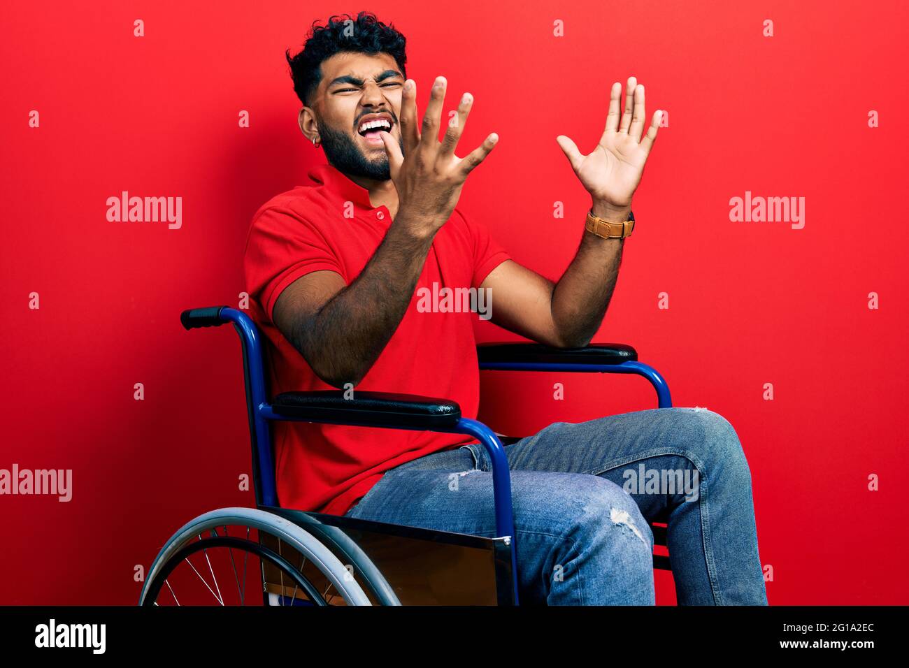 Arab man with beard sitting on wheelchair celebrating mad and crazy for ...