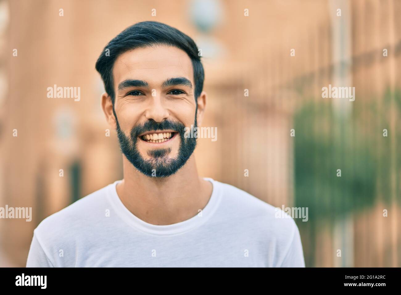 Young hispanic man smiling happy standing at the city Stock Photo - Alamy