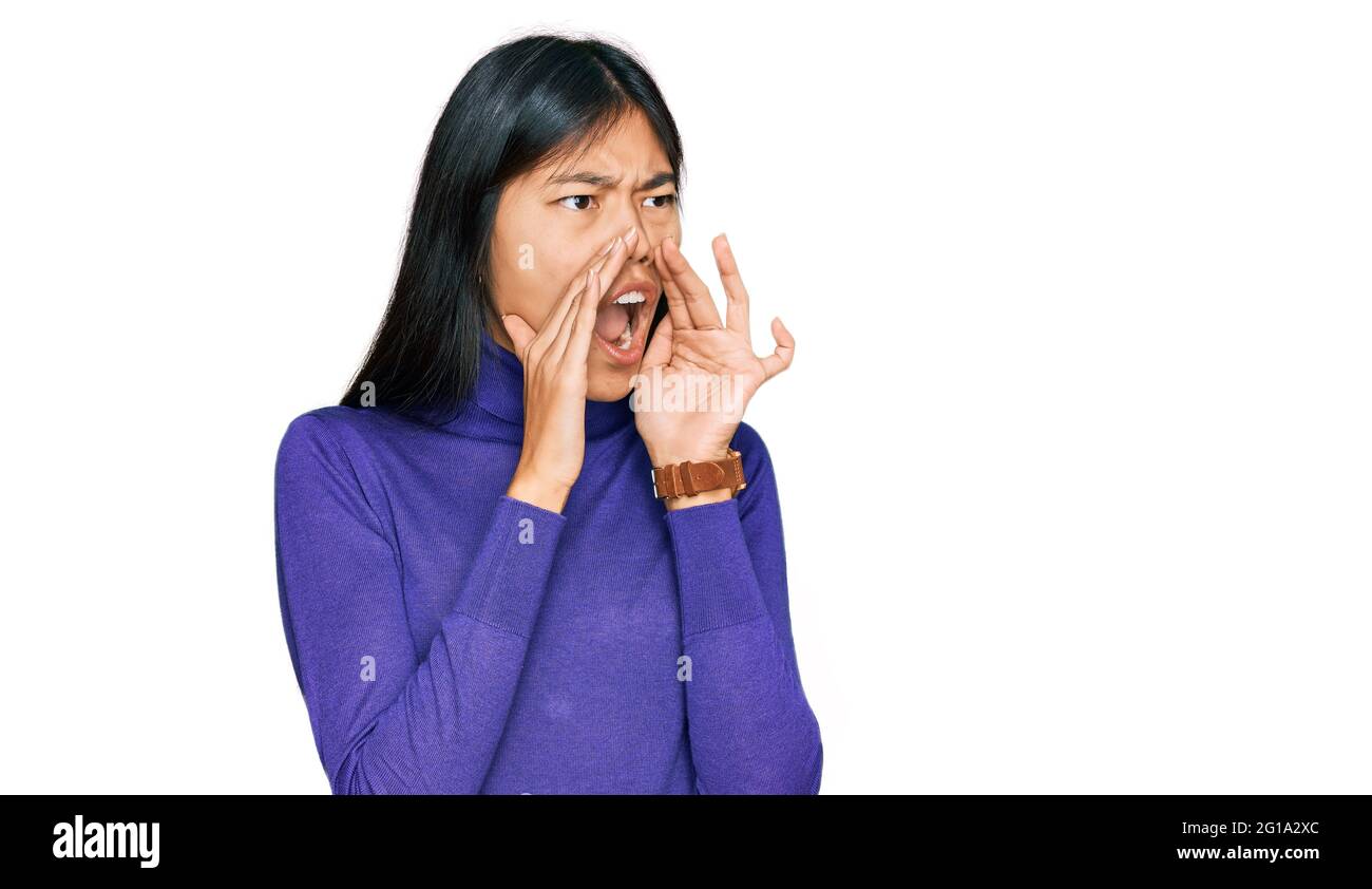 Beautiful young asian woman wearing casual clothes shouting angry out ...