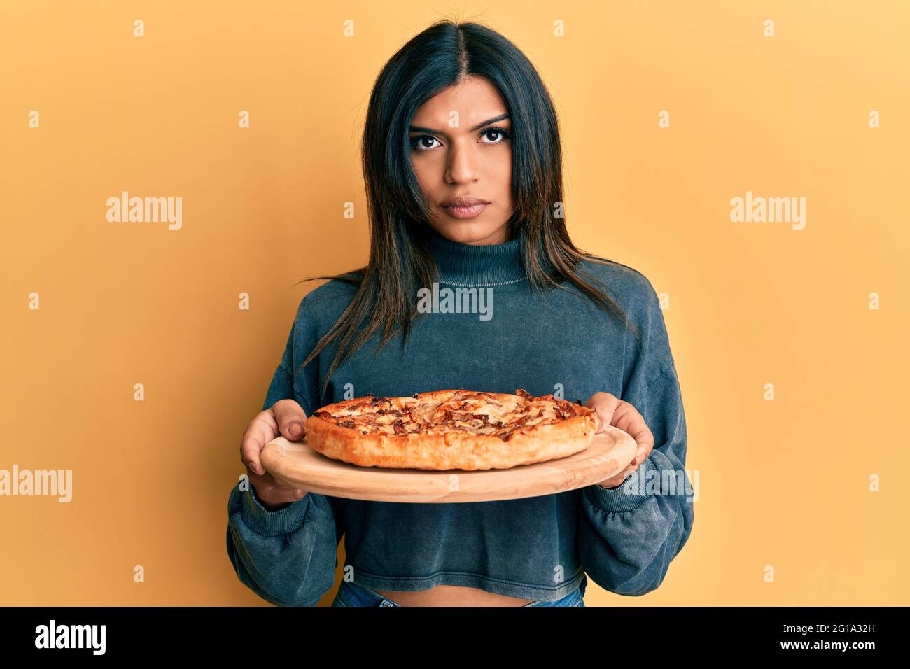 Young latin transsexual transgender woman holding italian pizza ...