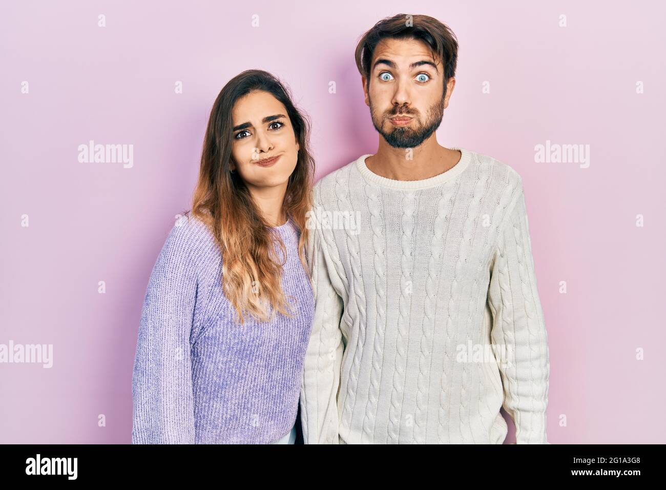 Young hispanic couple wearing casual clothes puffing cheeks with funny ...