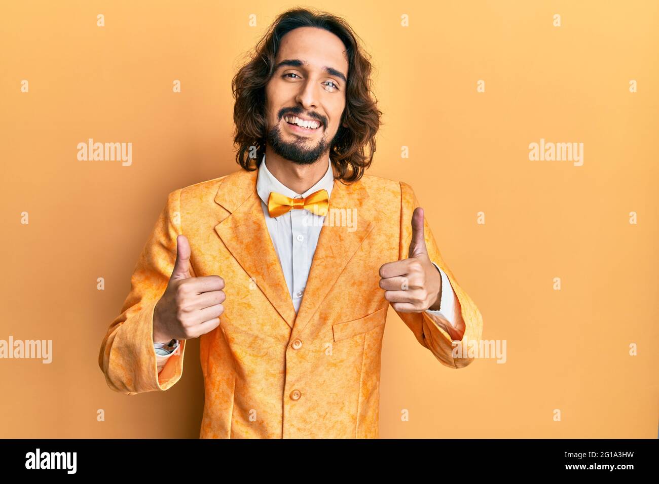 Young hispanic man wearing hipster elegant look success sign doing ...