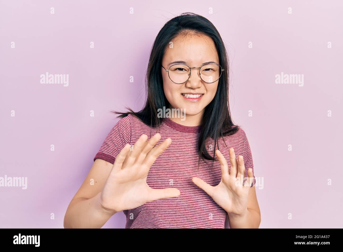 Young chinese girl wearing casual clothes and glasses disgusted ...