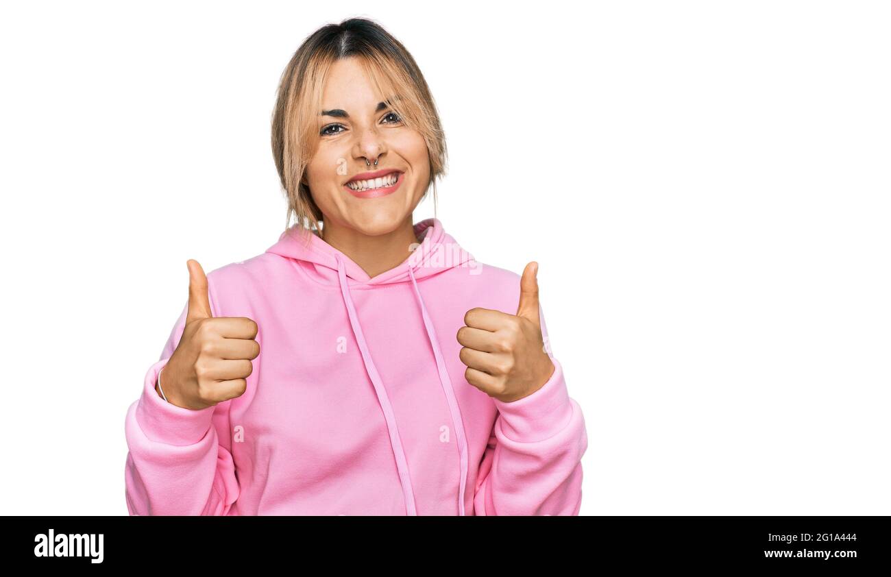 Young caucasian woman wearing casual sweatshirt success sign doing ...