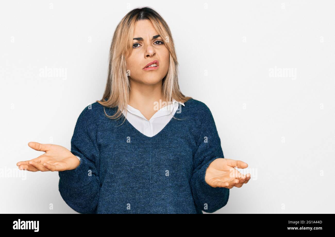 Young caucasian woman wearing casual clothes clueless and confused with ...