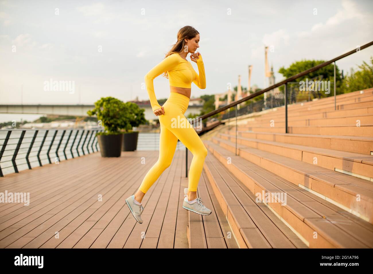 Young woman jogging up stairs hi-res stock photography and images - Alamy
