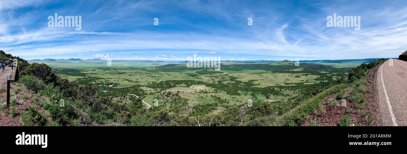 A panoramic view of green fields, hills and mountains from a highway ...