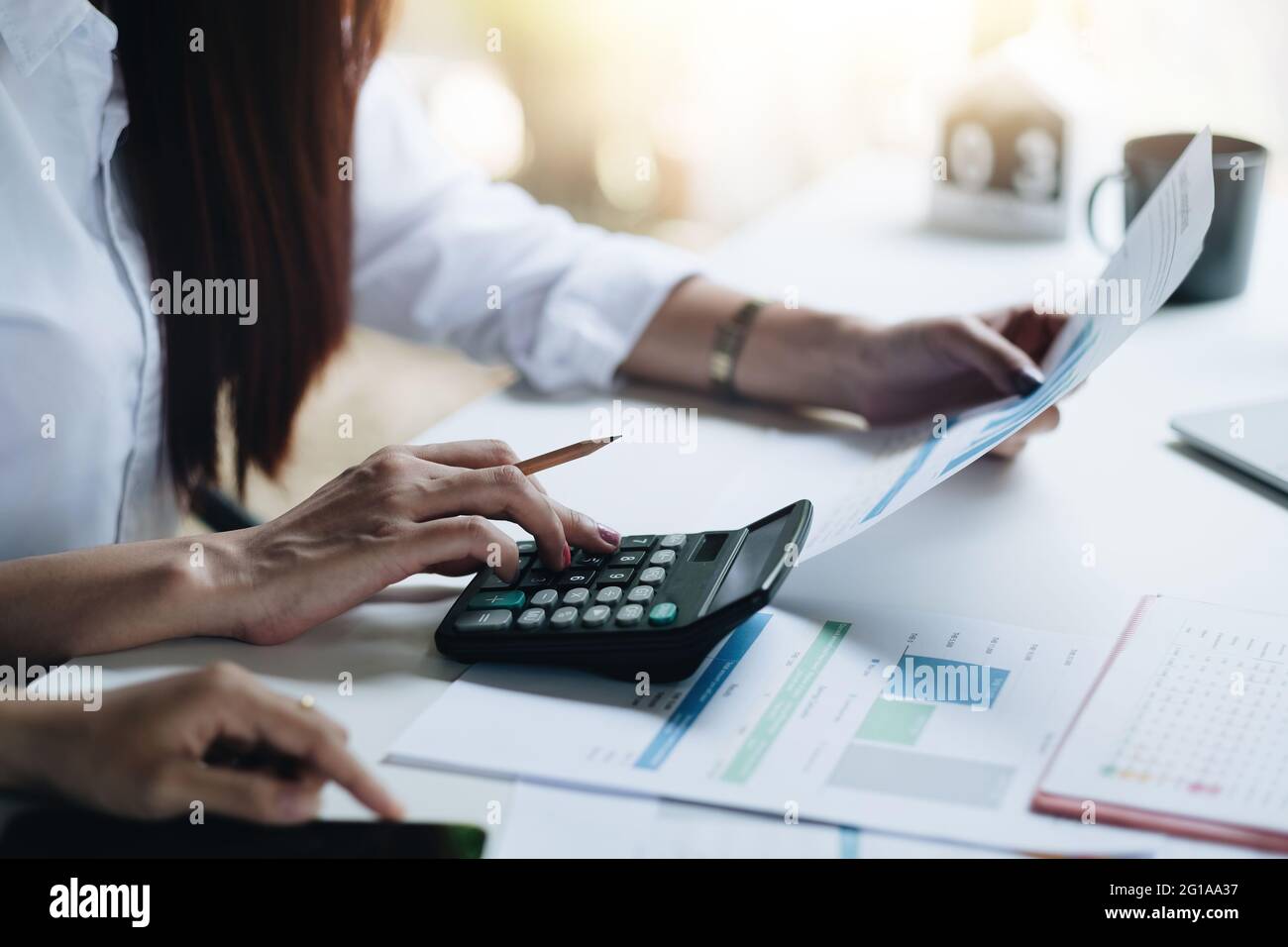 close up hand of accountant working on desk using calculator for ...