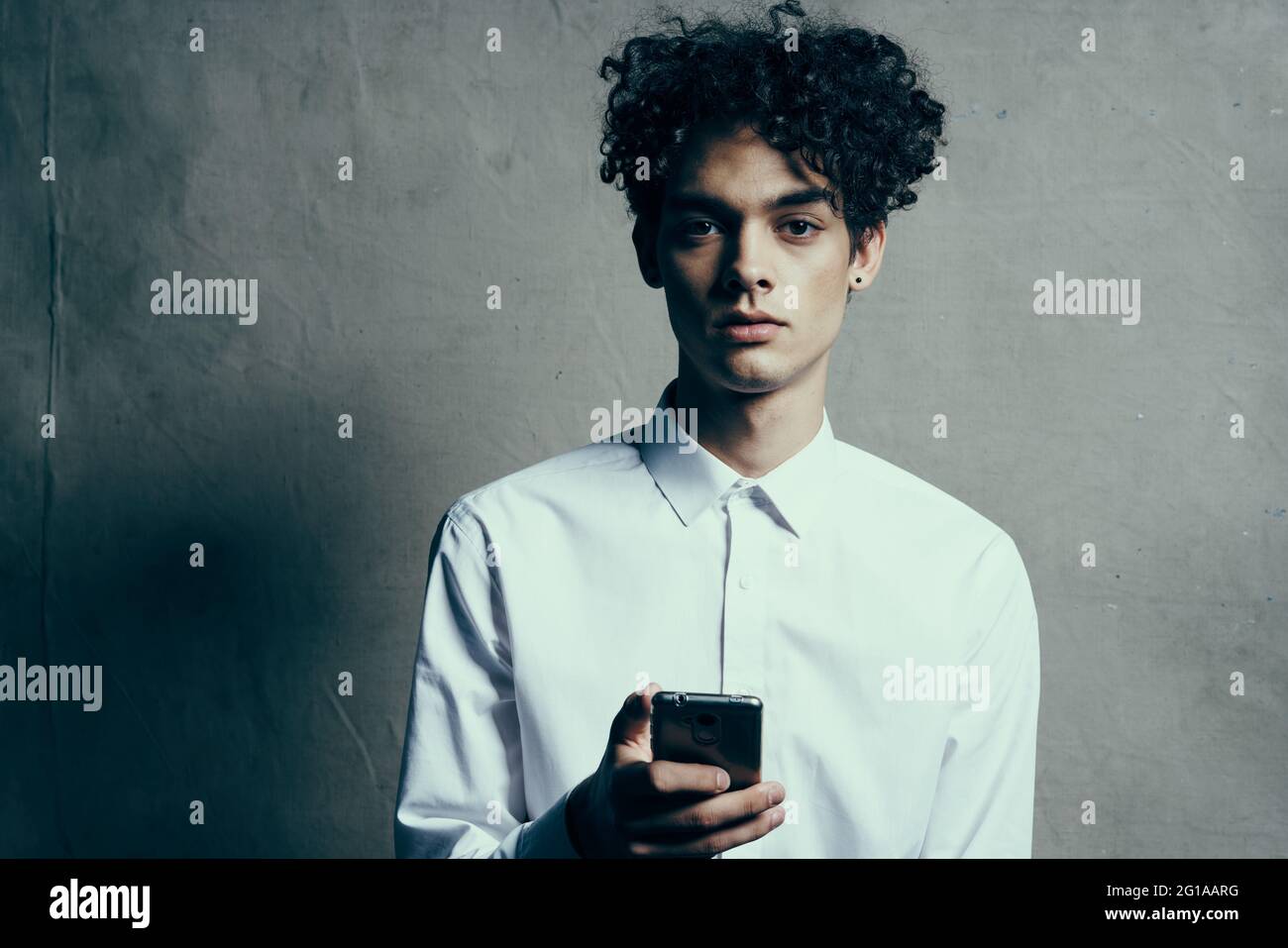 man with curly hair white shirt manager studio lifestyle Stock Photo ...