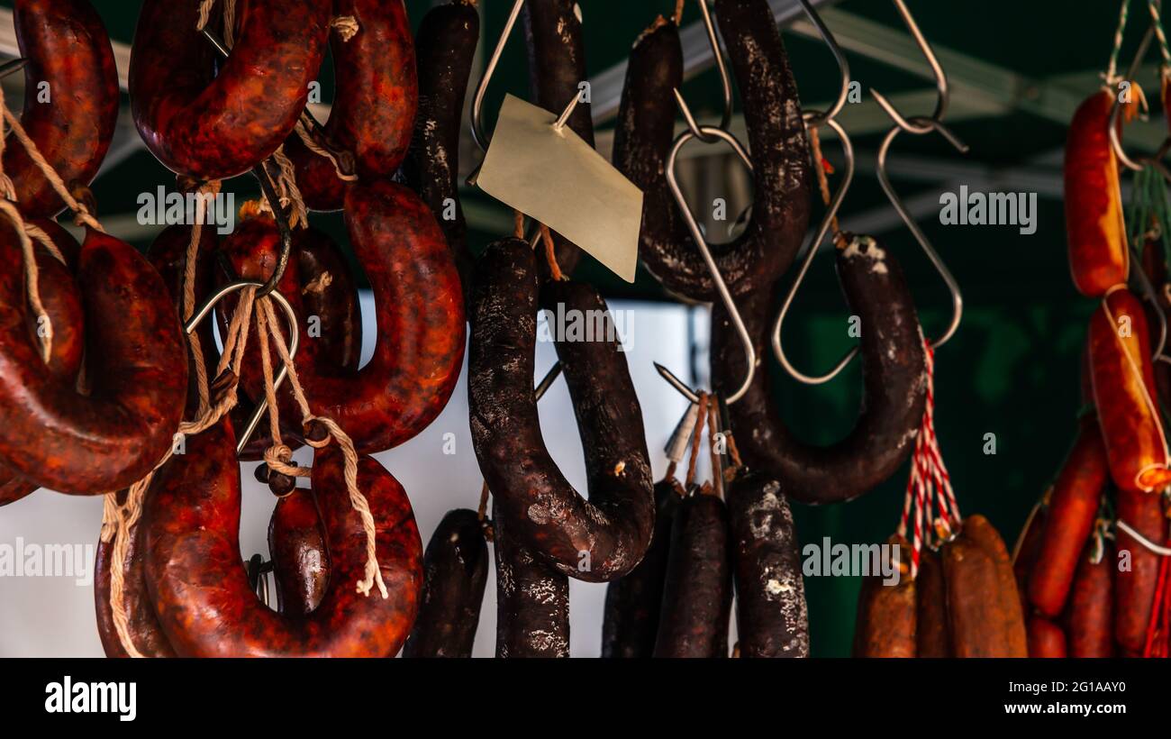 Typical Spanish sausages hanging on a village stall at the food market ...