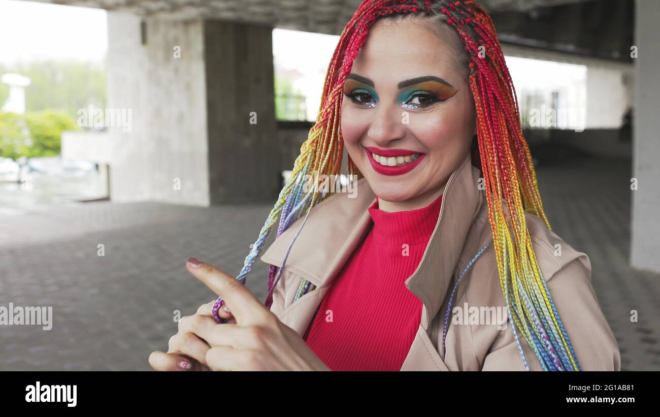 Fashionable girl in an elegant beige jacket with multi-colored African ...