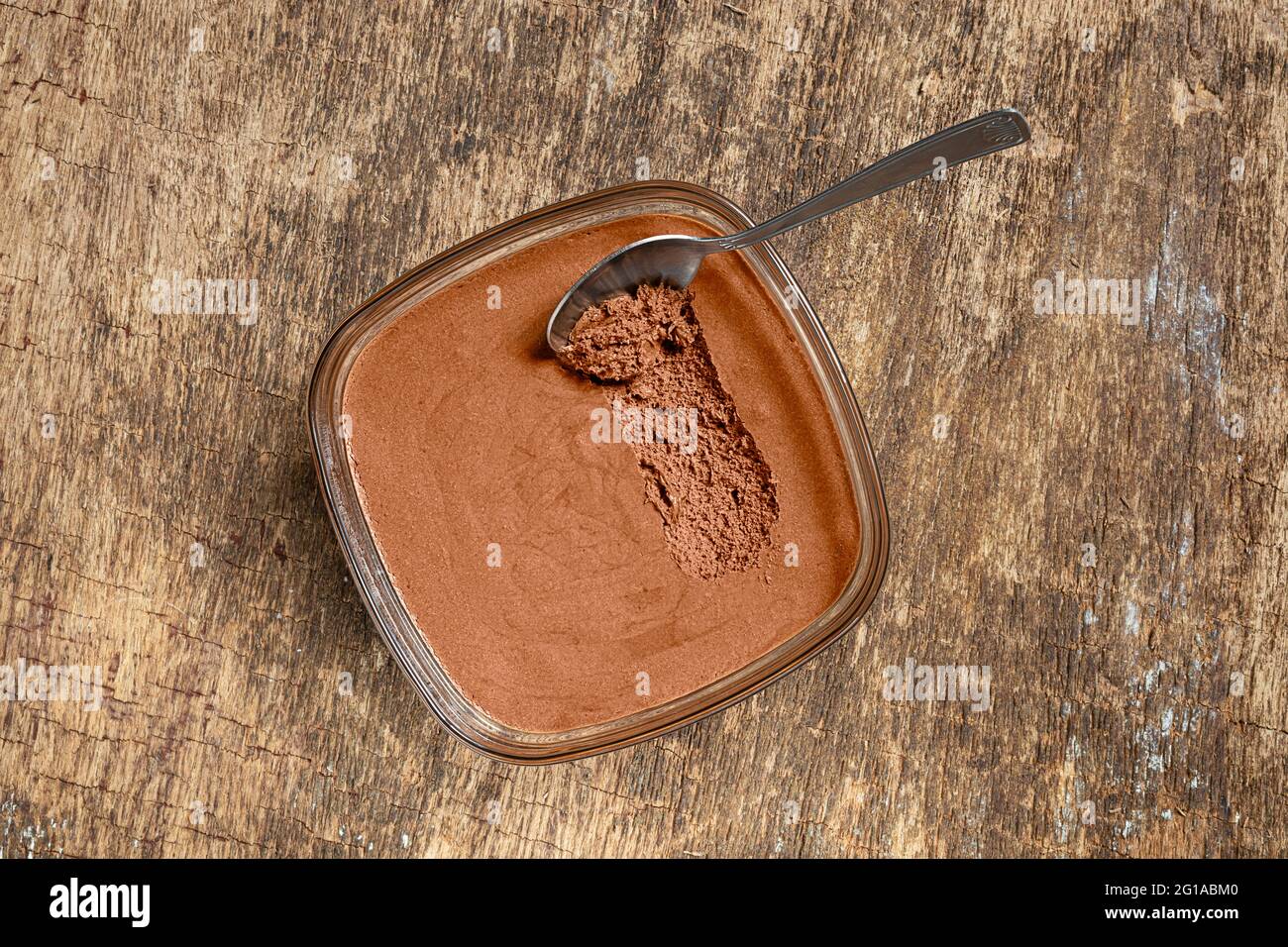 Traditional French chocolate mousse in a bowl and a spoon on the old ...