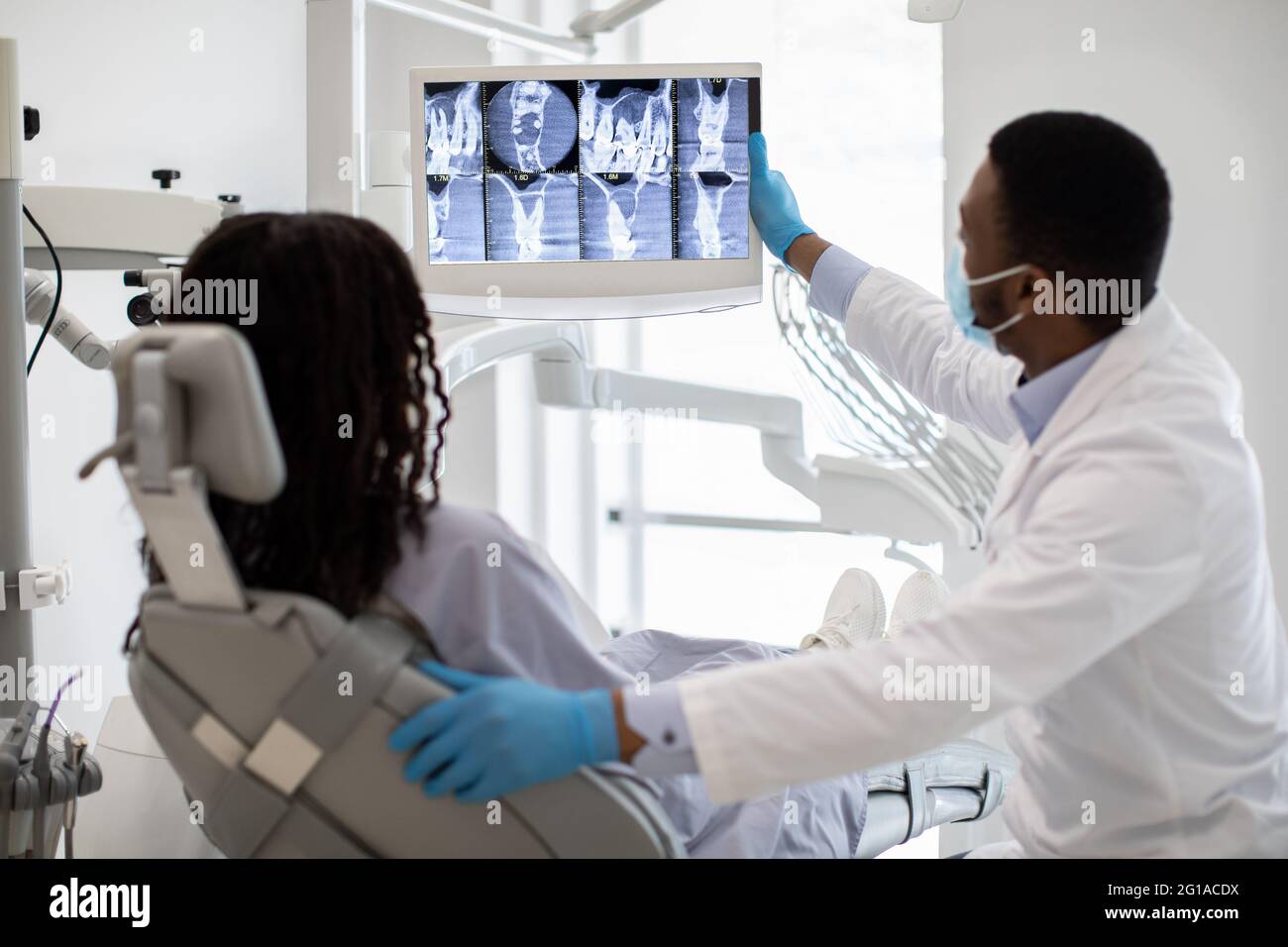 Professional Black Dentist Doctor And Female Patient Looking At Teeth ...